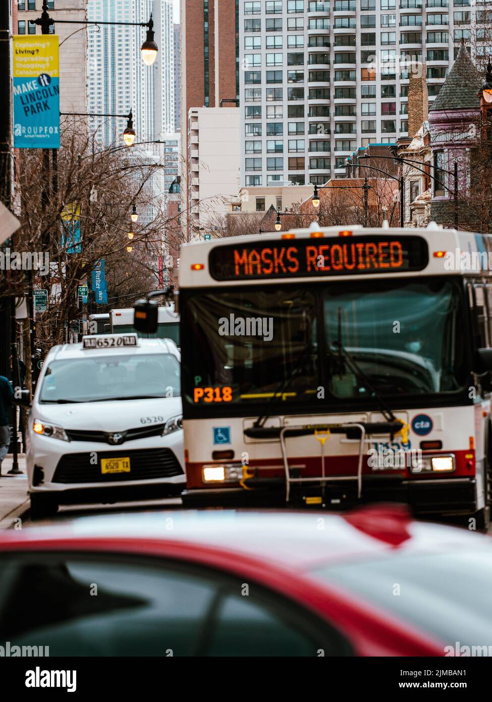 A vertical shot of a bus with a masks required sign in Chicago, USA ...