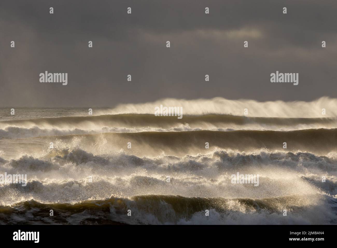 A windy landscape of the ocean waves under the cloudy sky Stock Photo ...