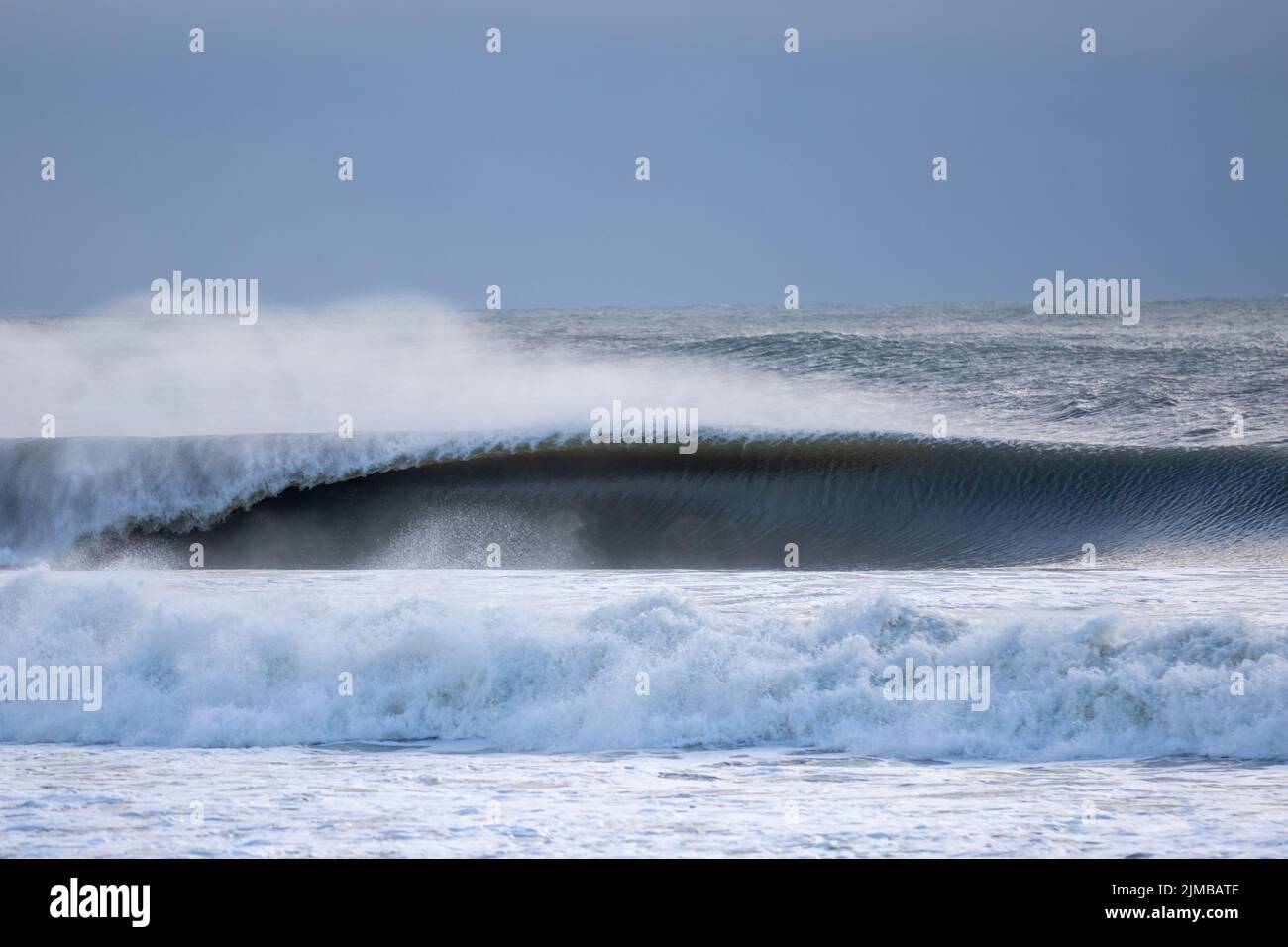 Beautiful ocean waves forming a tube during a windy weather Stock Photo ...