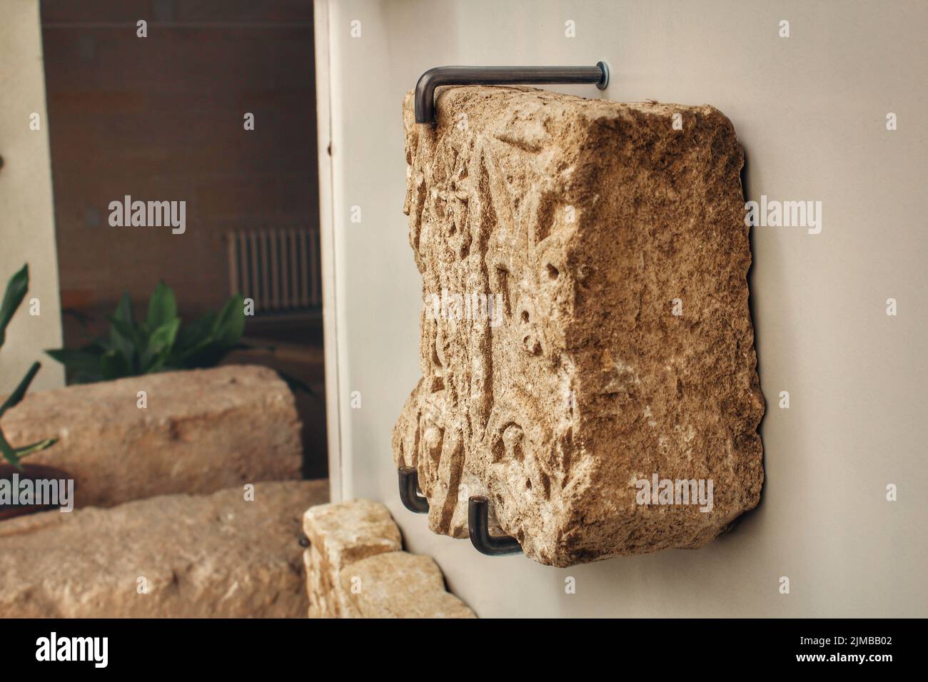 A selective of an ancient carved stone hanging from a wall Stock Photo ...