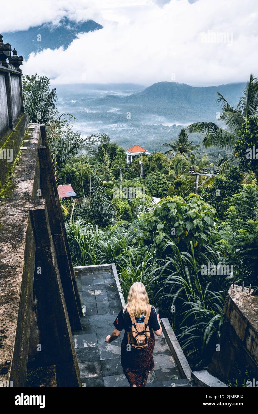 A female descending the stairs in a tropical environment in Bali Stock ...