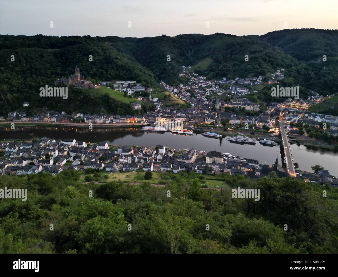 An aerial view of a coastal town with a port and a bridge in a rural ...