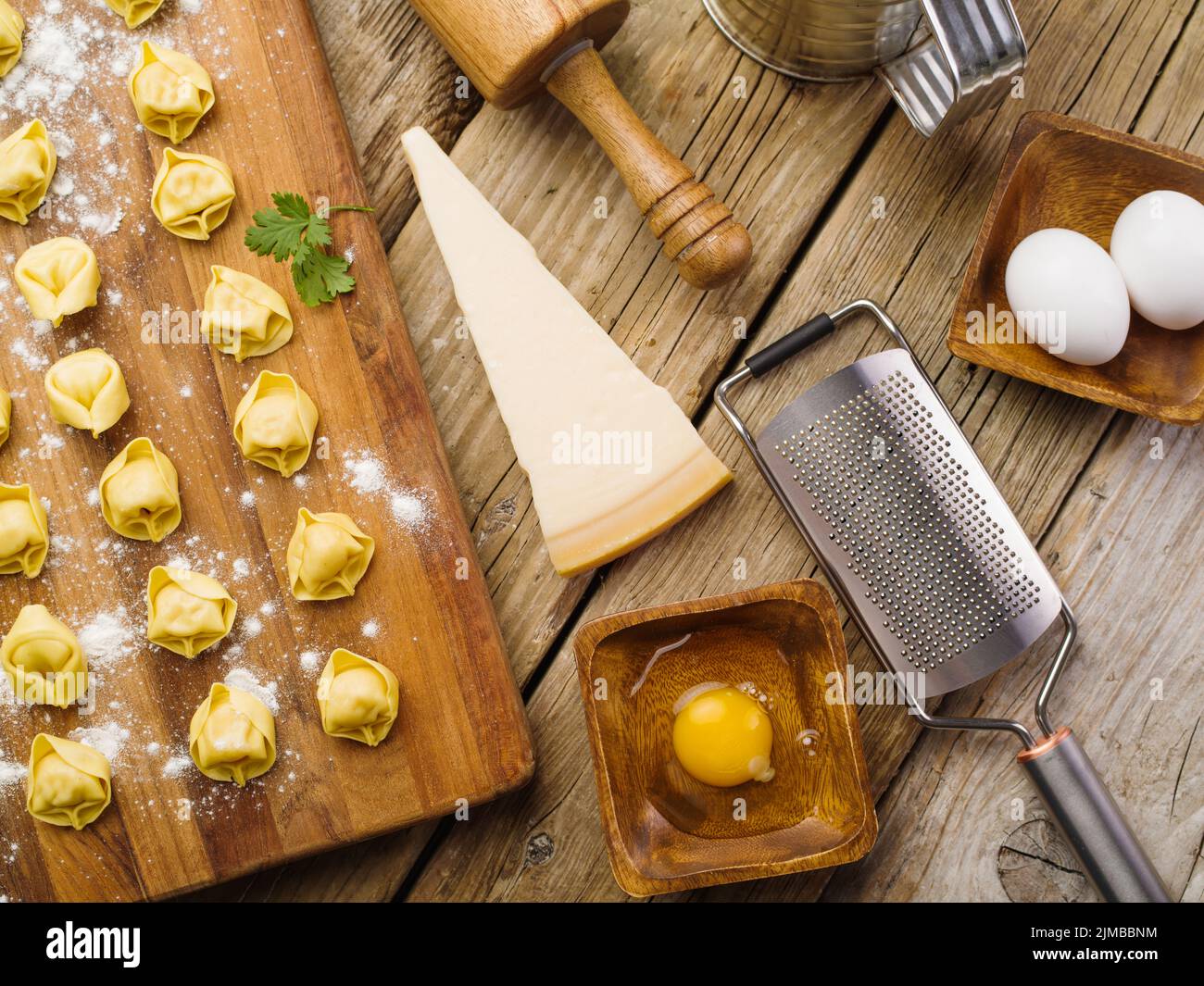 Cooking homemade dumplings with meat filling. Dumplings on a wooden ...