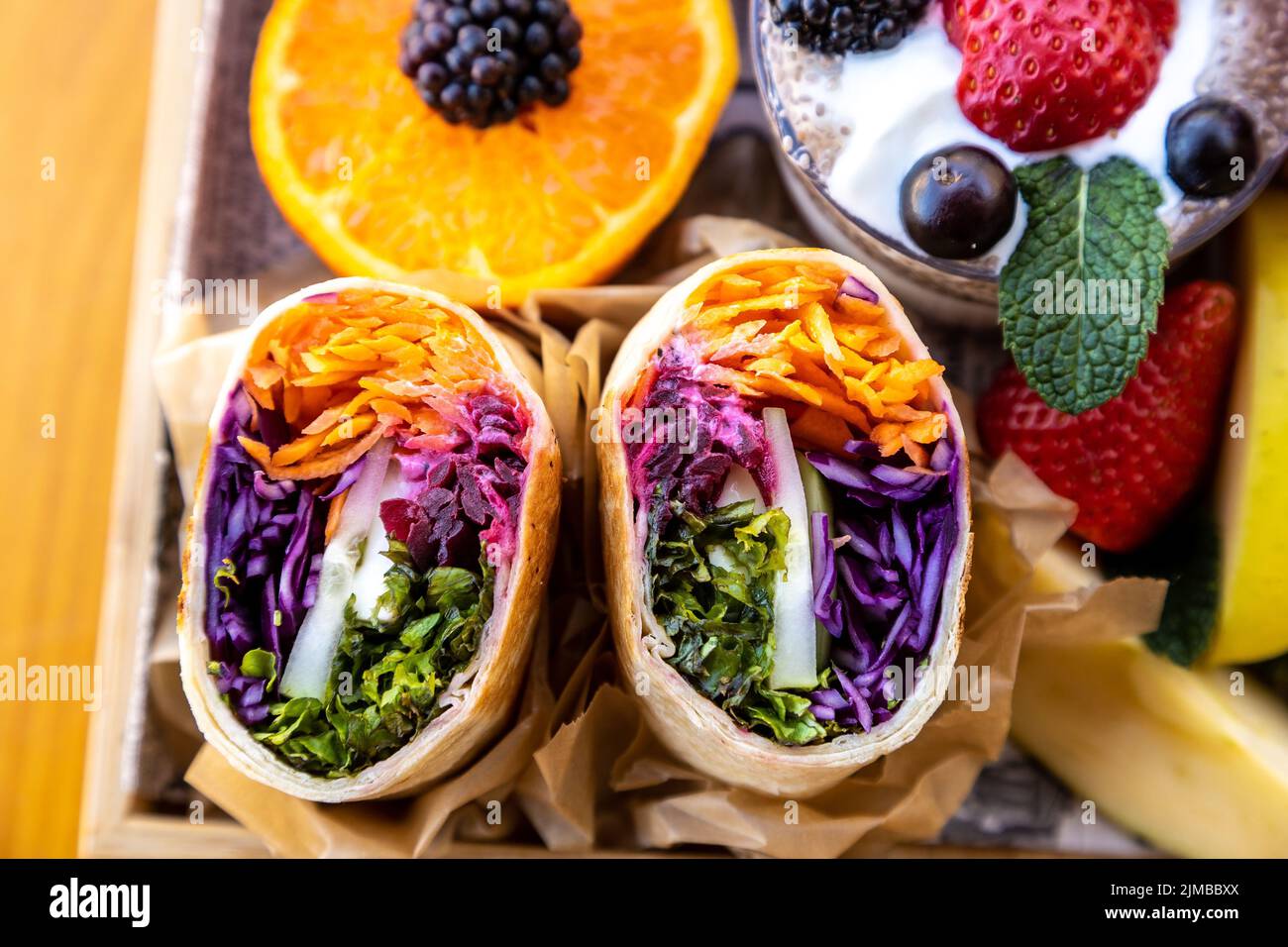 A closeup of assorted fruits, cheese, bread, and dessert on a platter ...