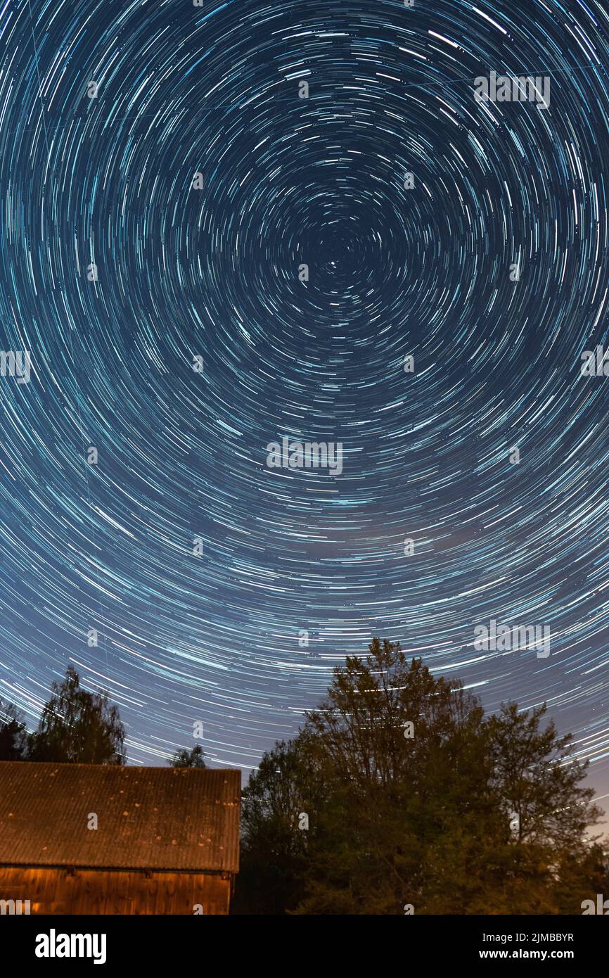 A vertical shot of stars in the sky in a long exposure photography ...