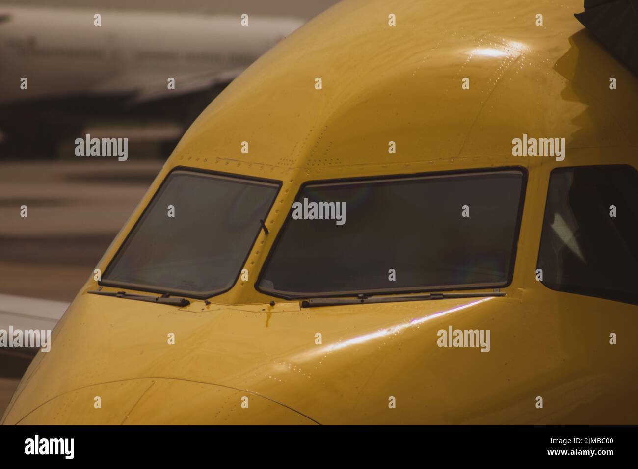 A closeup shot of a yellow airplane in an airport Stock Photo - Alamy