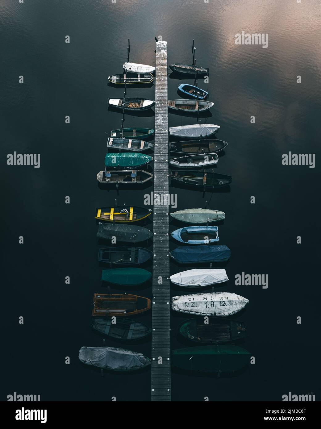 A vertical aerial view of several sailing boats parked at harbor in ...