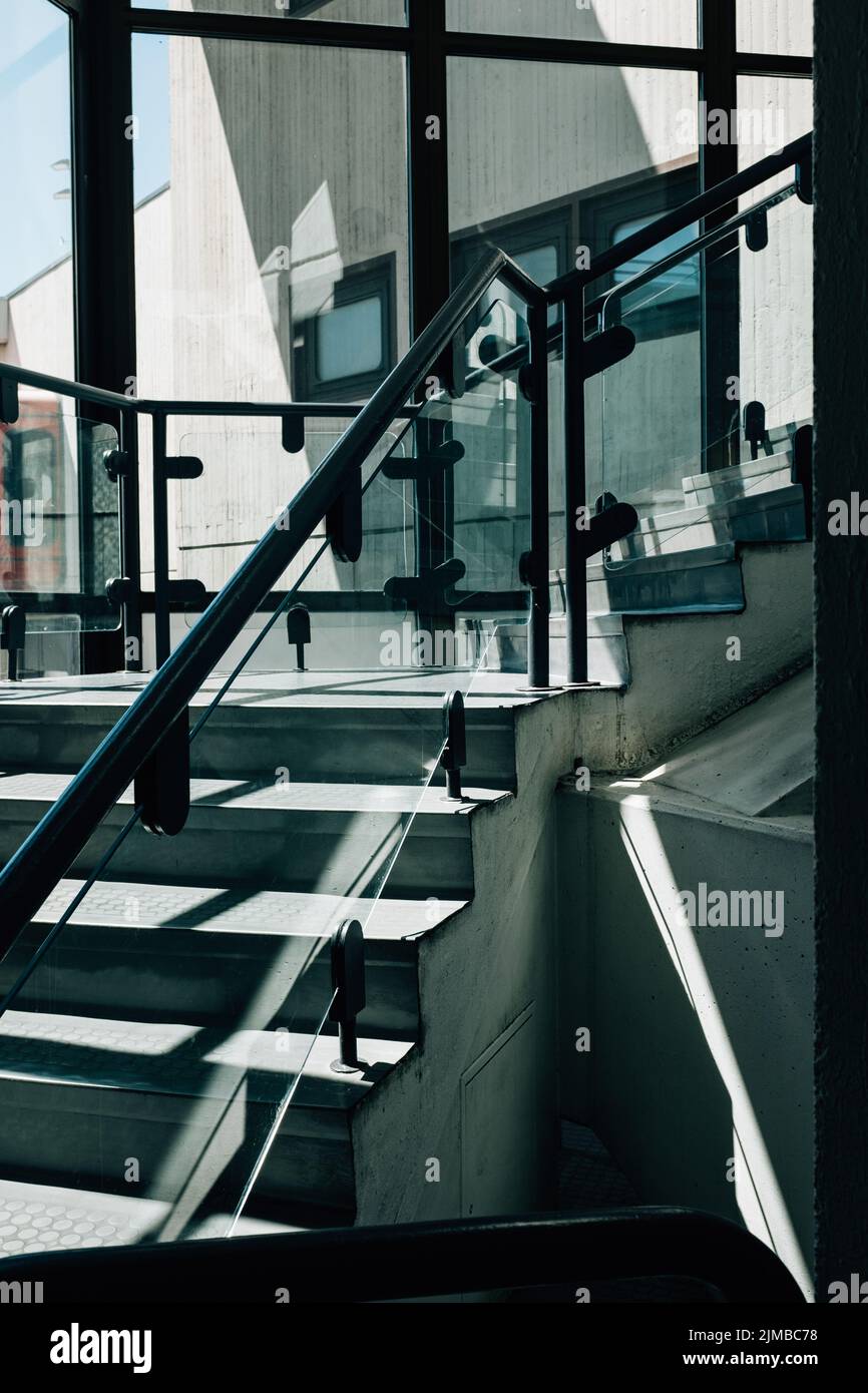 A vertical shot of stairs with glass railings Stock Photo - Alamy