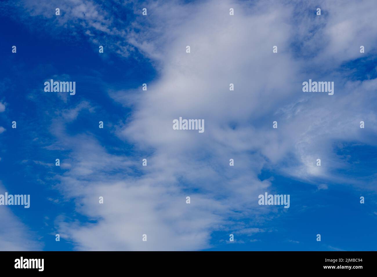 A scenic view of white fluffy heaps of clouds with cotton-like ...
