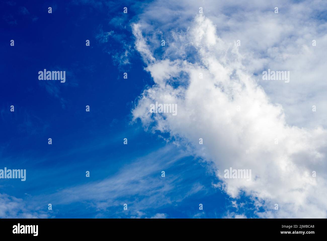A scenic view of white fluffy heaps of clouds with cotton-like ...