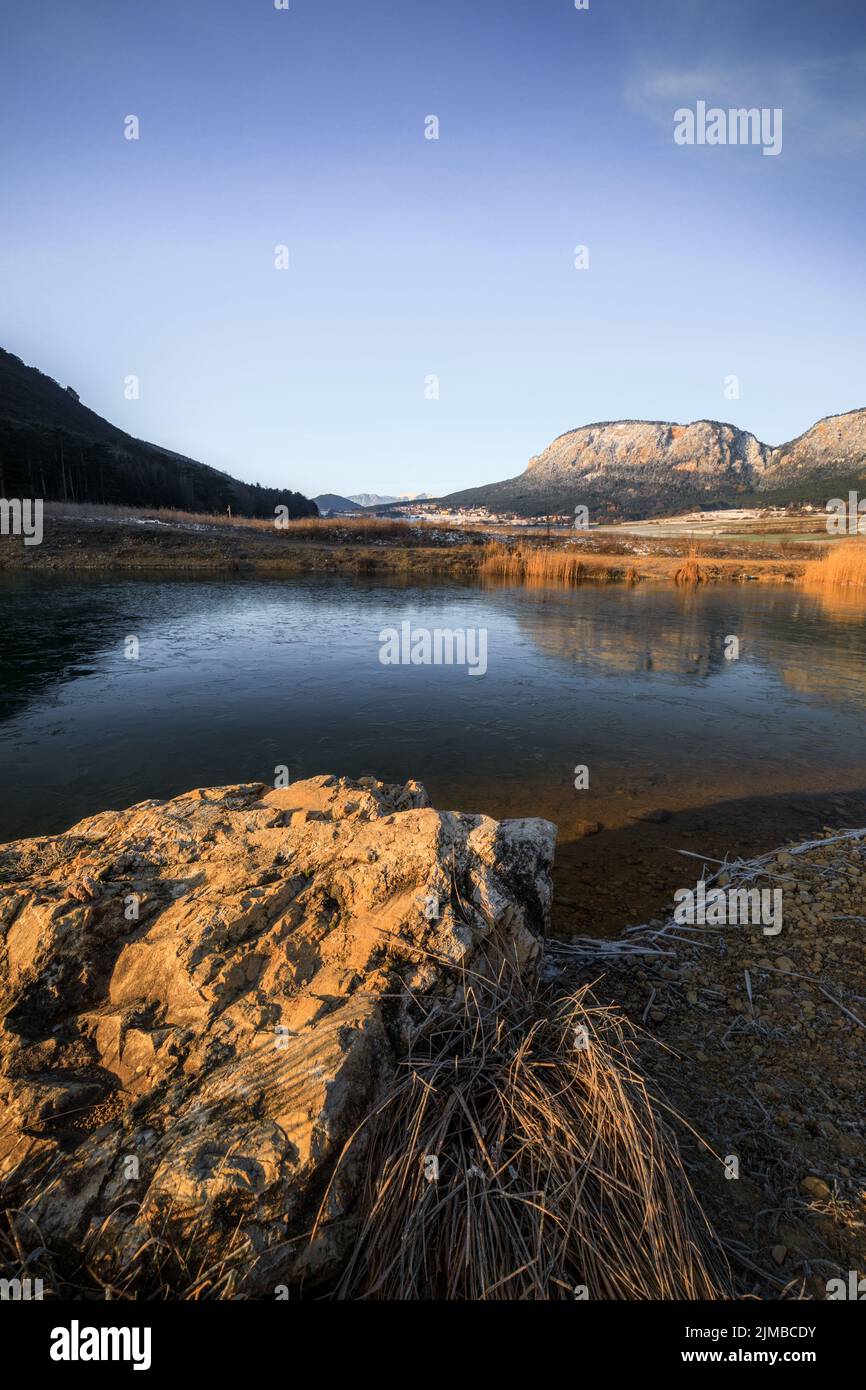 Beautiful landscape with high rocks with illuminated peaks, stones in ...