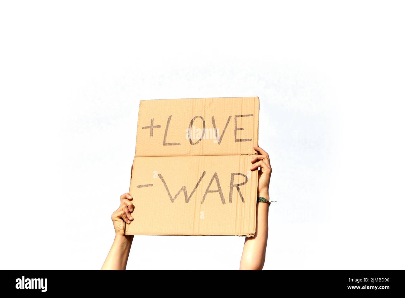 A Cardboard Signs saying More Love, Less War held by two hands on a ... A Cardboard Signs saying More Love, Less War held by two hands on a ...