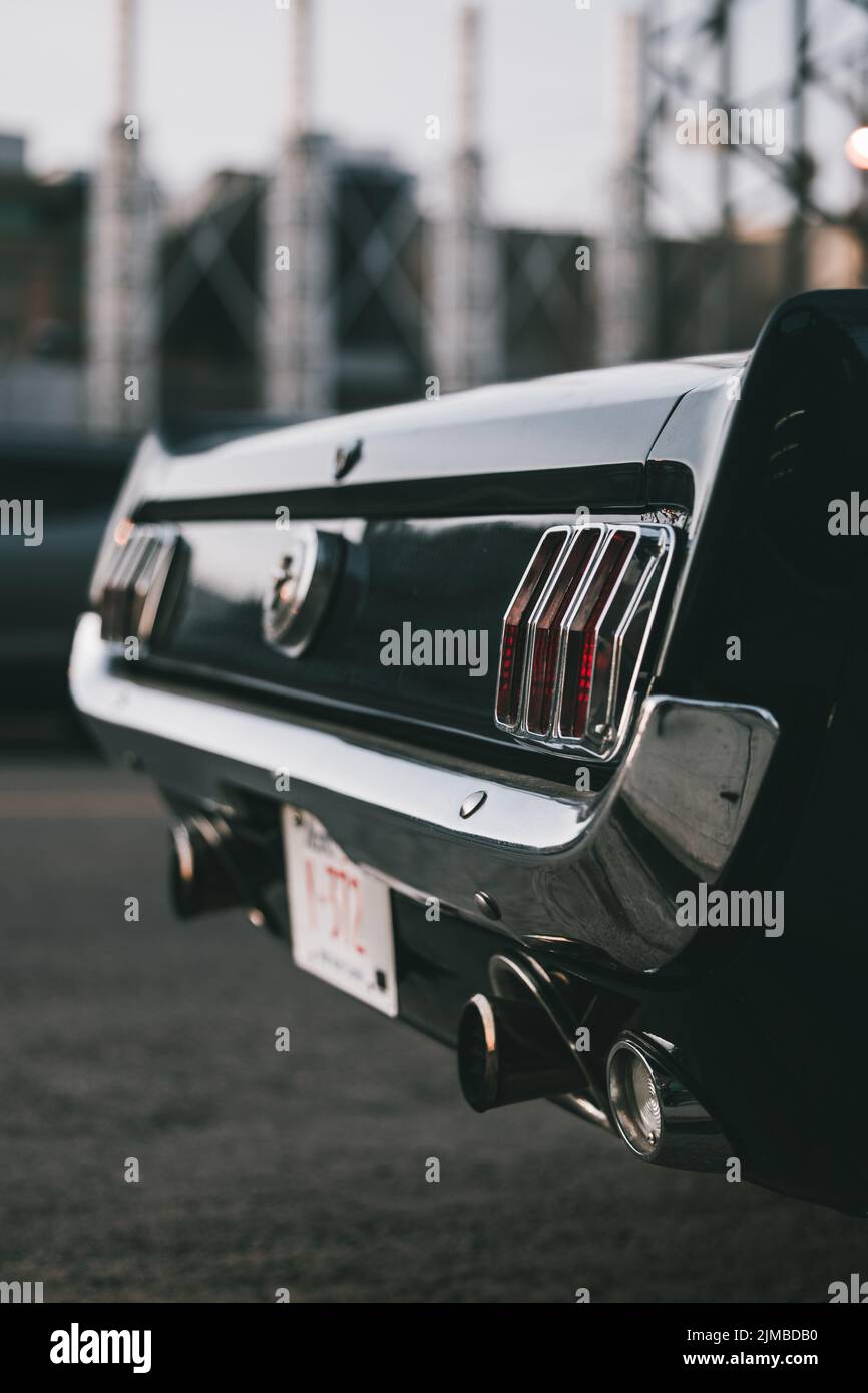 Vertical image of the back end of a classic Ford Mustang muscle car ...