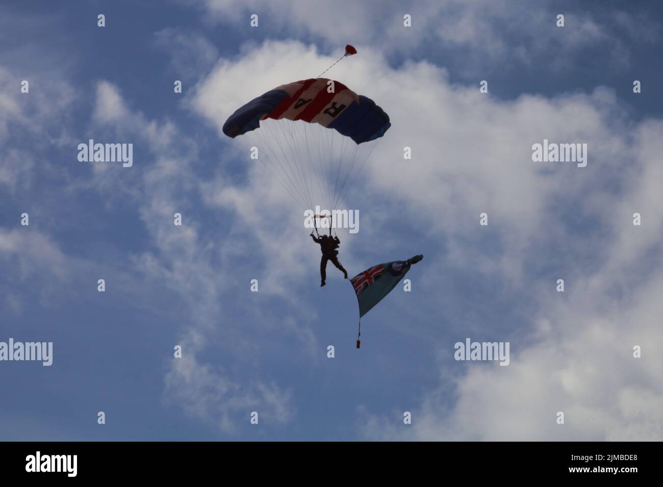 A closeup of an RAF Falcons parachute display team member flying with a ...
