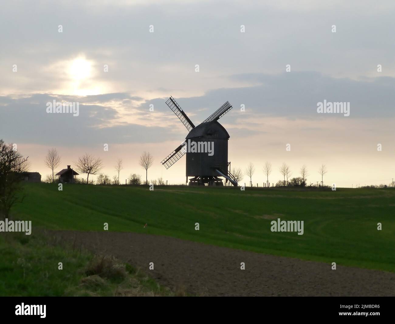 Traditional old windmill on nature background Stock Photo - Alamy