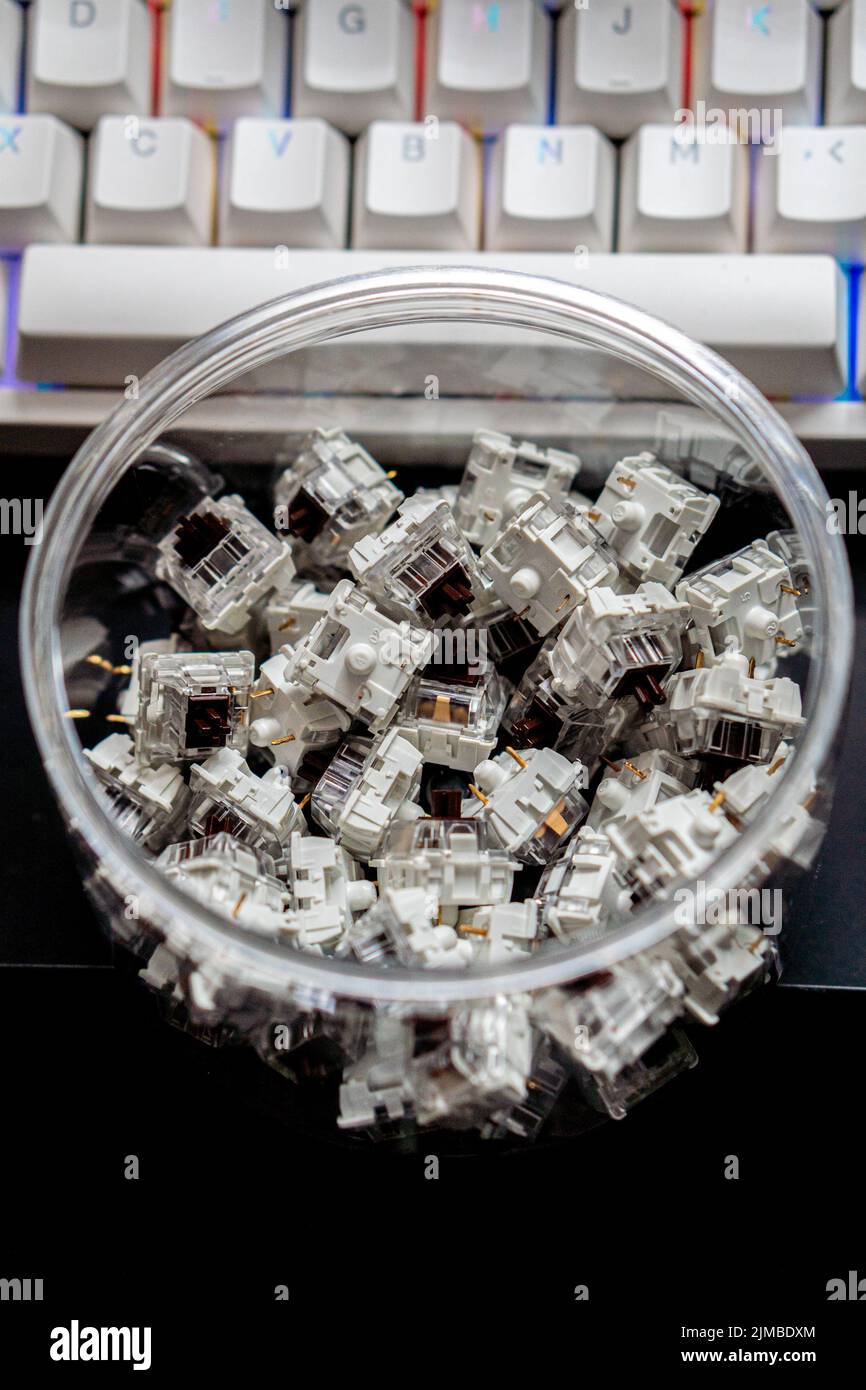 A vertical closeup of mechanical keyboard switches piled in a ...