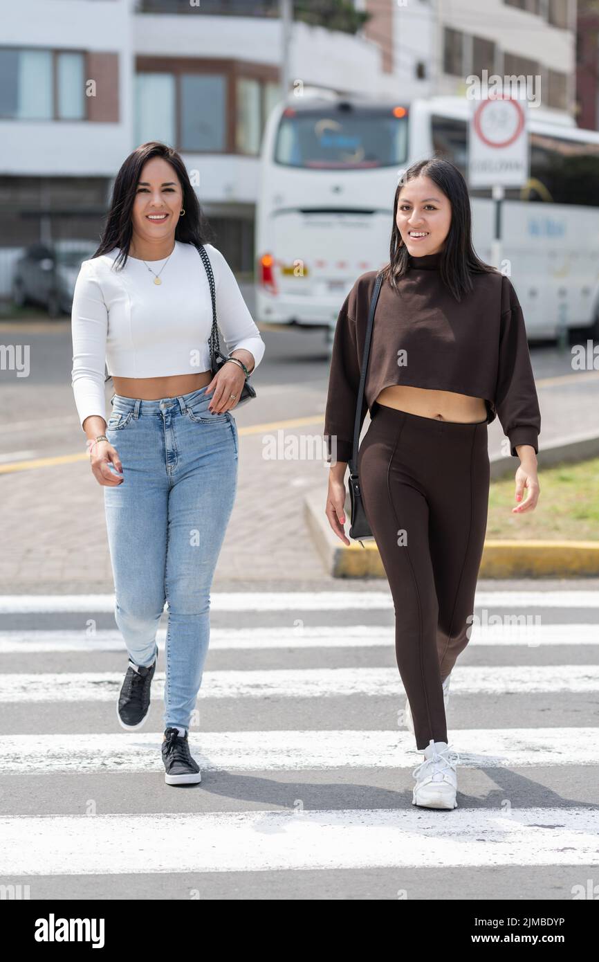 Vertical photo of two friends crossing a pedestrian crossing Stock ...