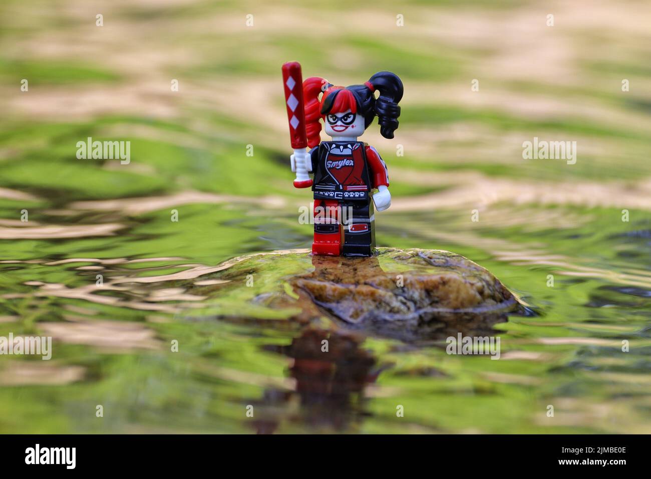 Toy female character figure, smiling, standing and holding a baseball ...