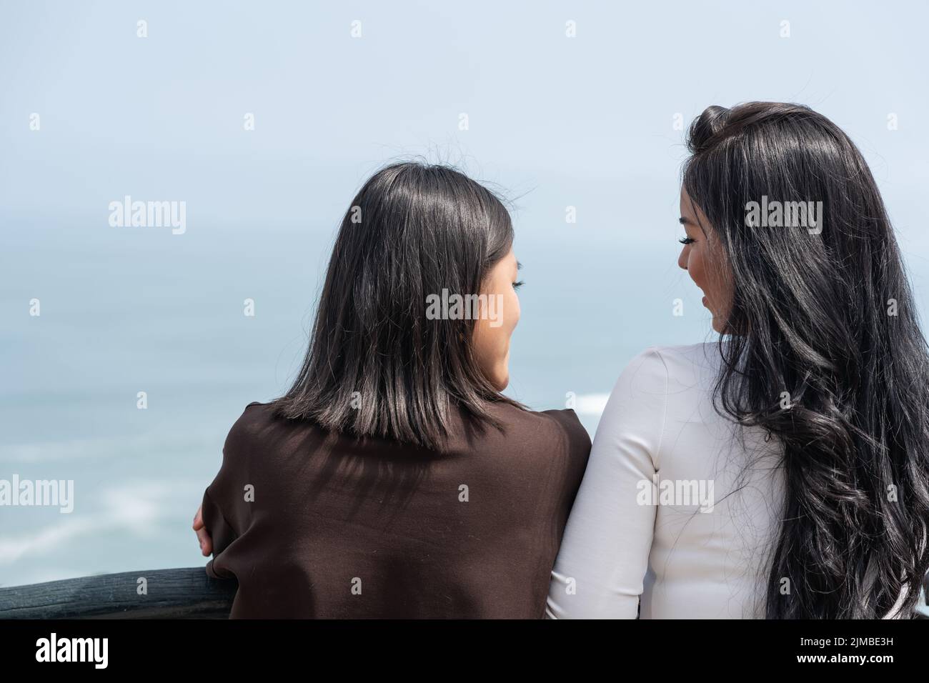 Back of two women gazing the horizon from the viewpoint of Miraflores ...