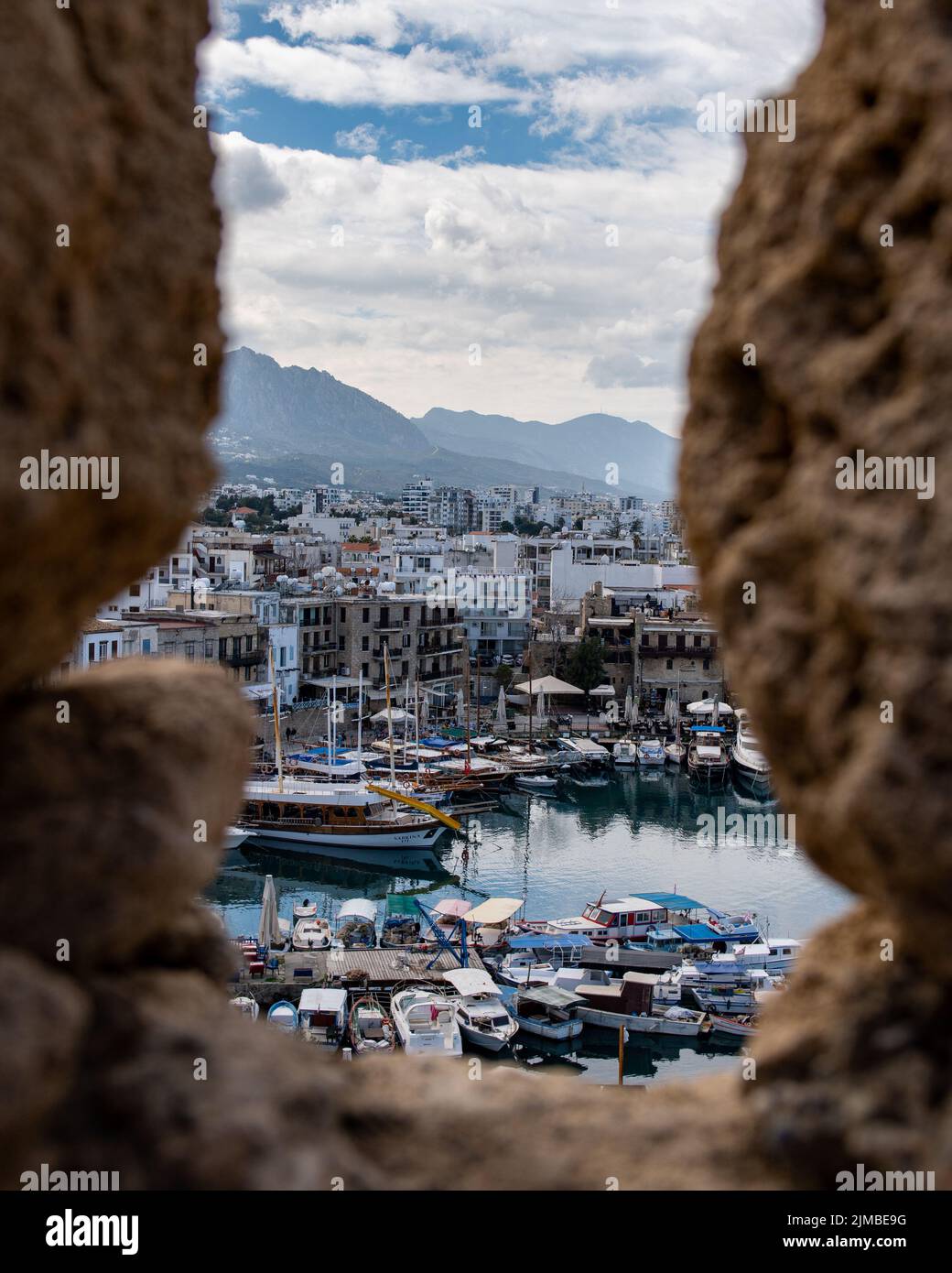A scenic View of a historic Kyrenia harbor through stone window of the ...