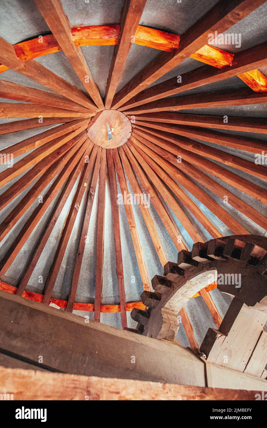 A vertical shot of the windmill's interior with a circular wooden roof ...