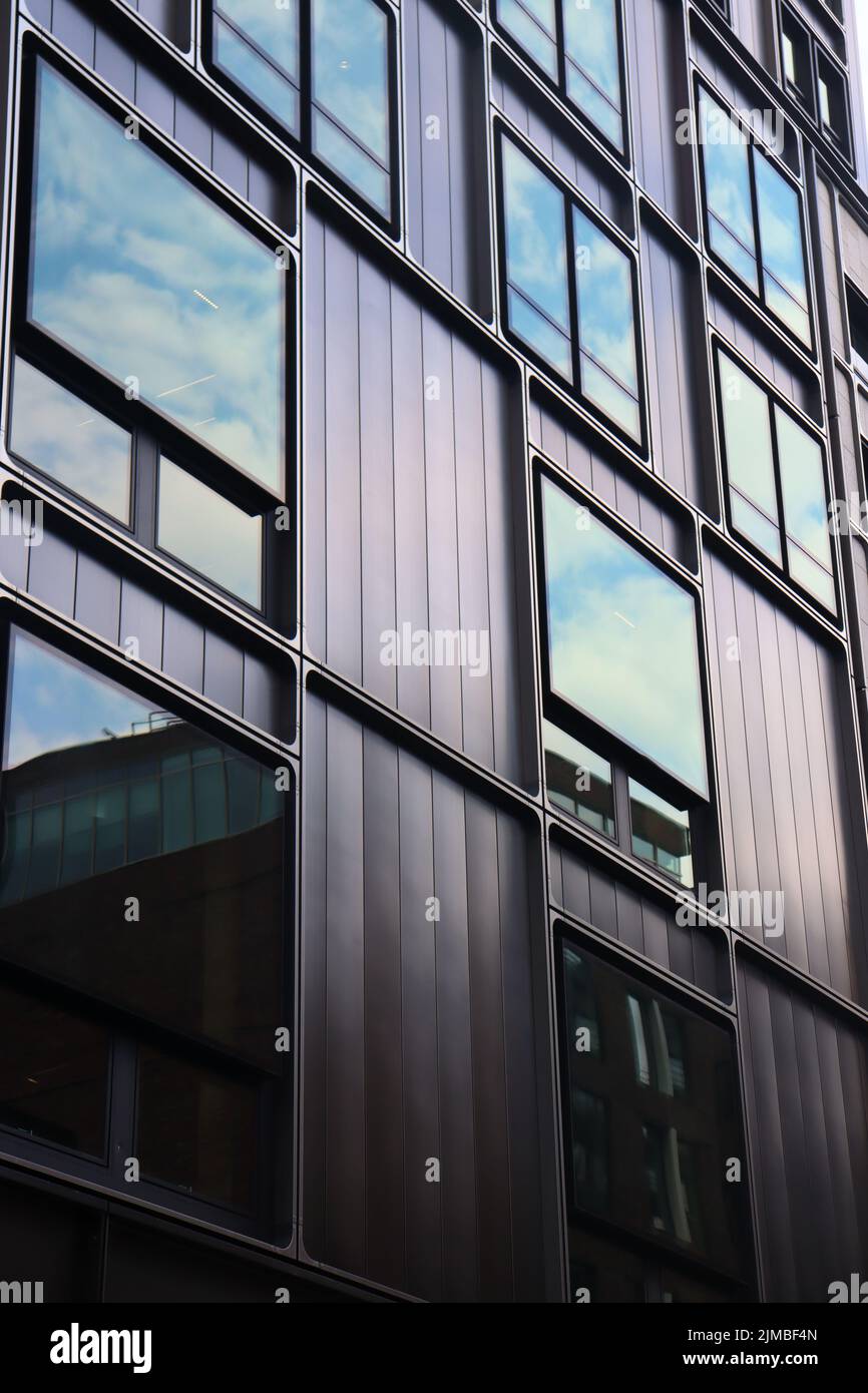 A vertical shot of a modern glass architectural building with ...