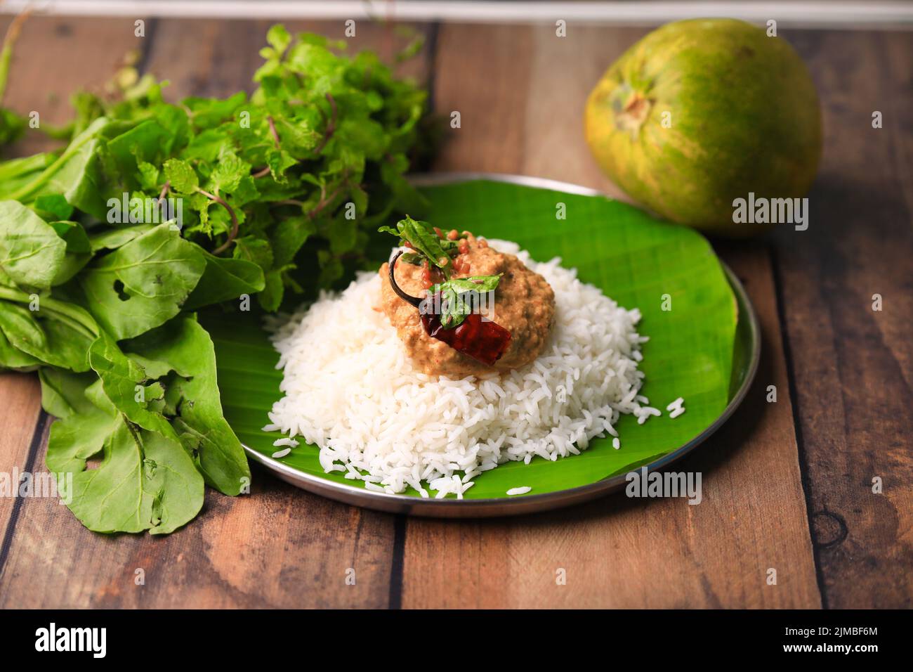 rice with chutney,rice with pickle served in a banana leaf with ...