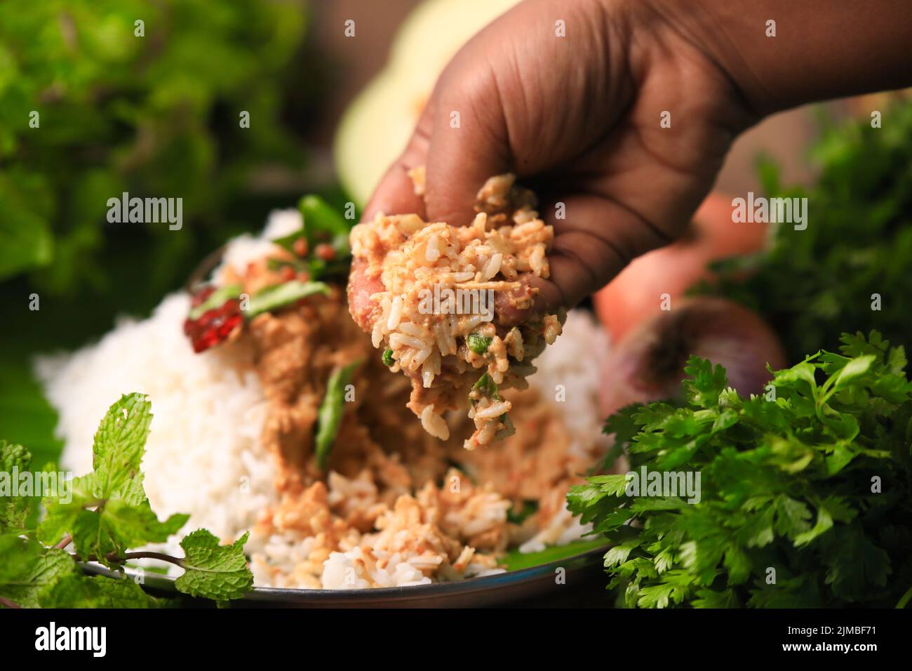 rice with chutney,rice with pickle served in a banana leaf with ...