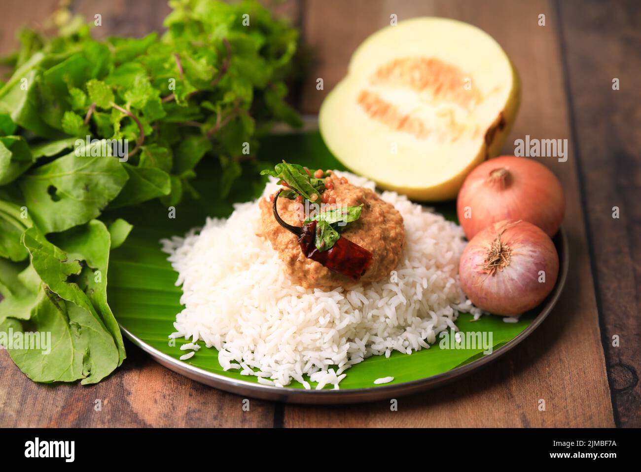 rice with chutney,rice with pickle served in a banana leaf with ...