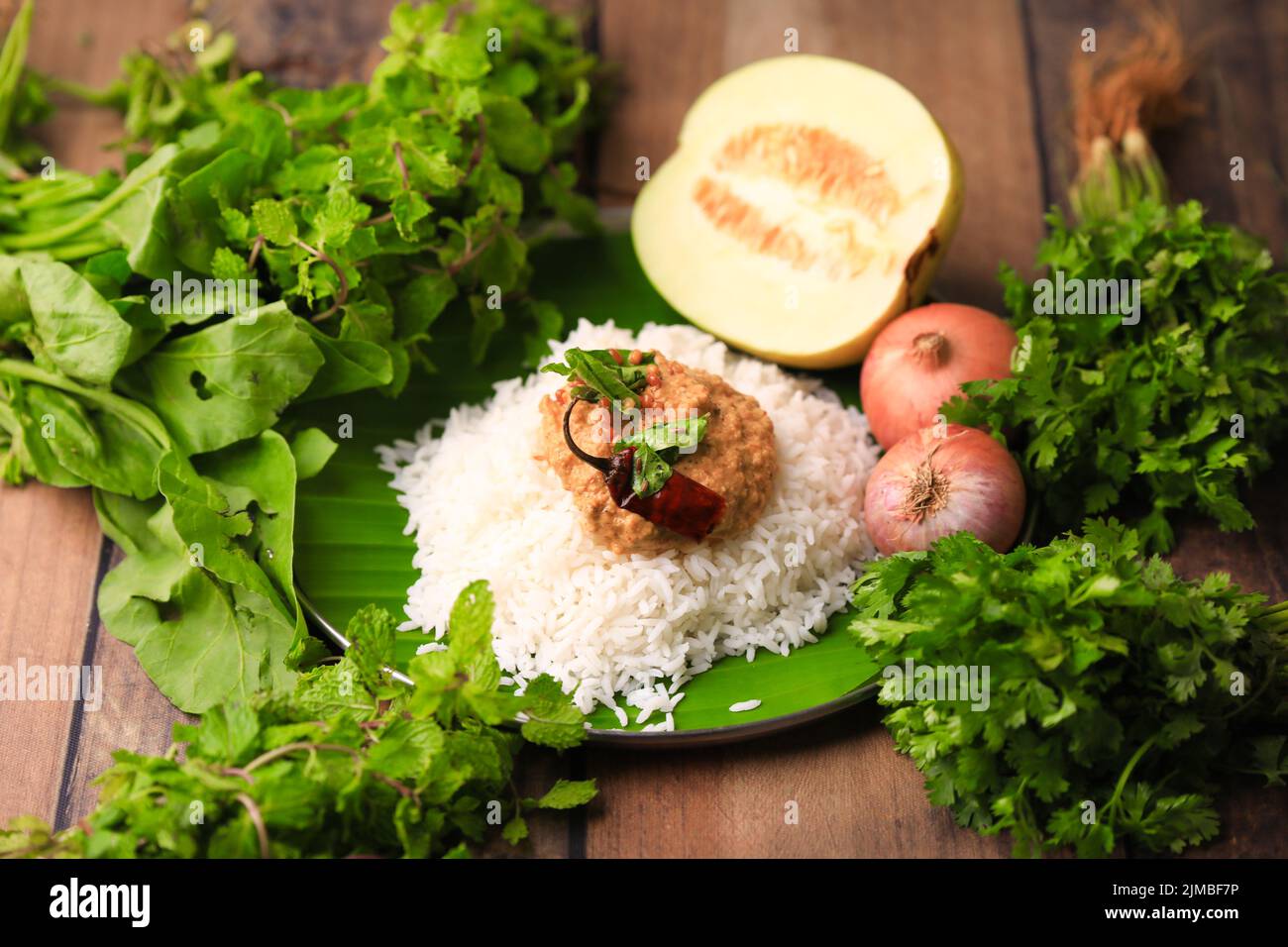 rice with chutney,rice with pickle served in a banana leaf with ...