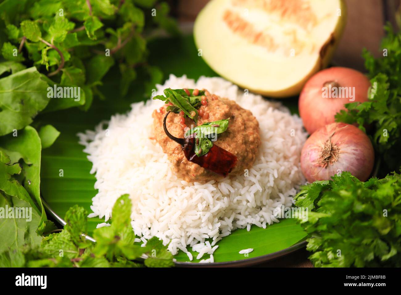 rice with chutney,rice with pickle served in a banana leaf with ...