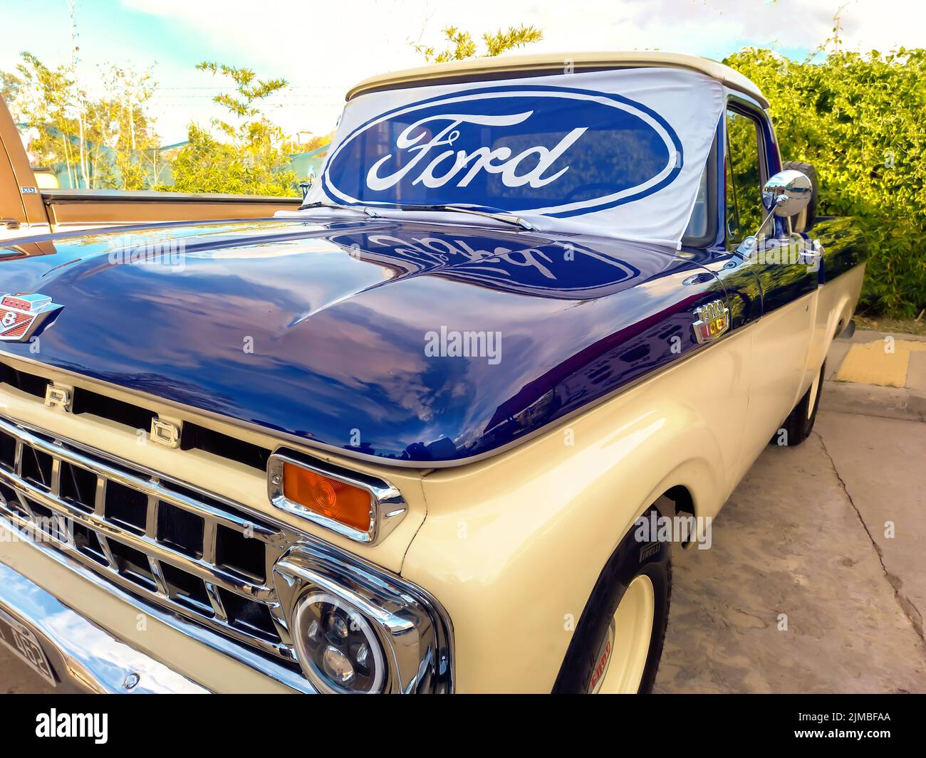 Ford blue oval logo and brand on the windshield of an old F100 V8 ...