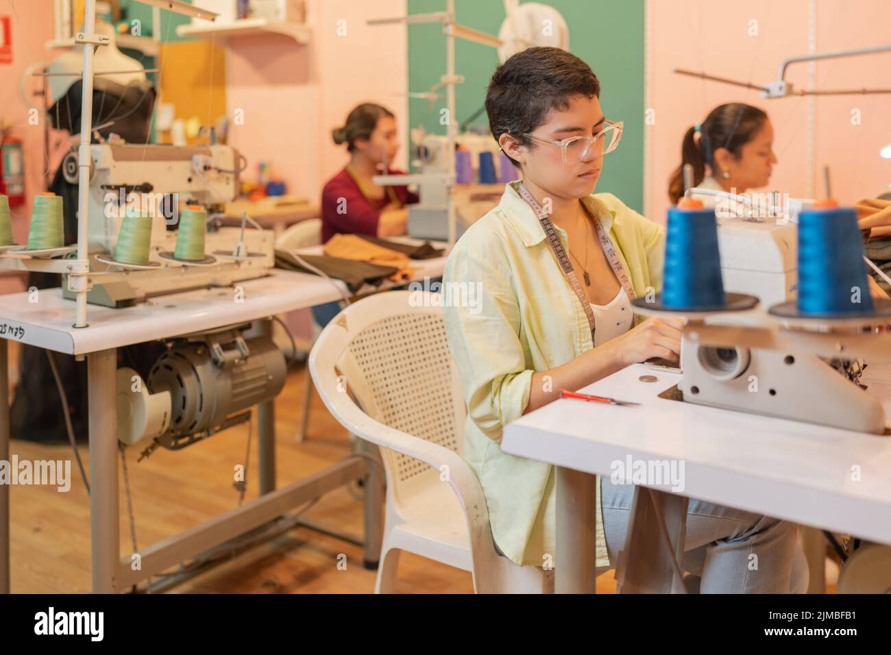 Group of three women working in a sewing workshop Stock Photo - Alamy