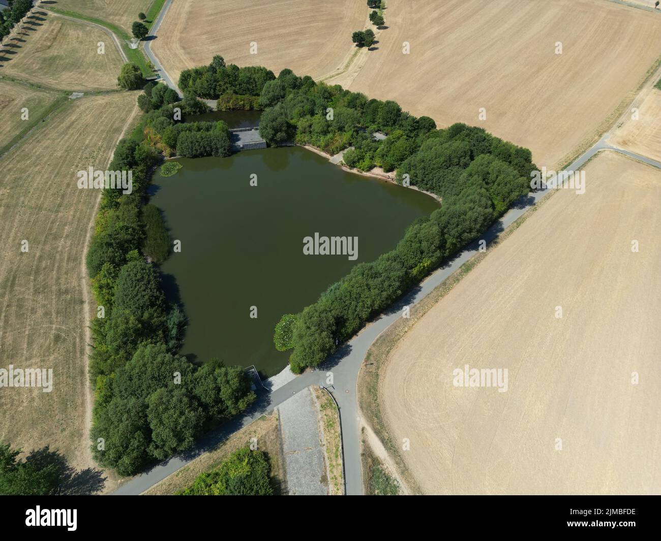 Top view of lake surrounded by lush trees on the territory of ...