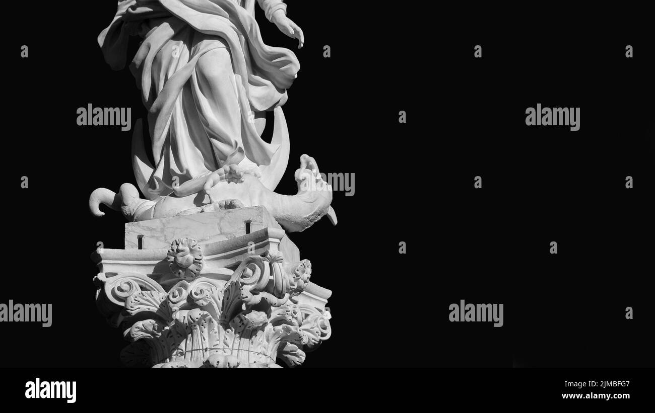 Good vs Evil. Statue of Virgin Mary of the Stars crushing dragon and ...