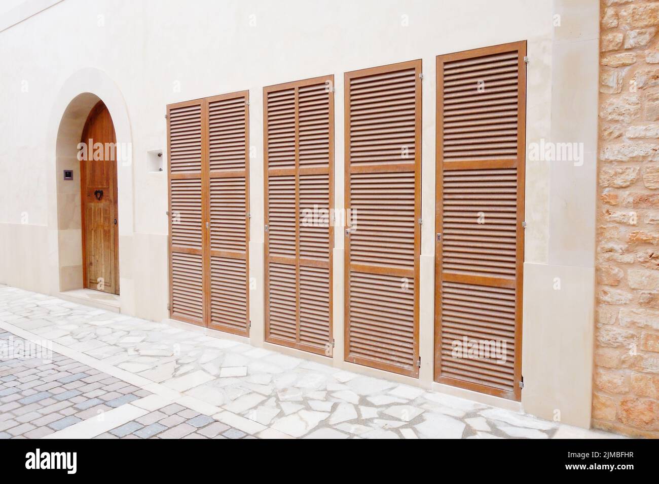 A view of Japanese wood shutters next to a wooden arched door Stock ...