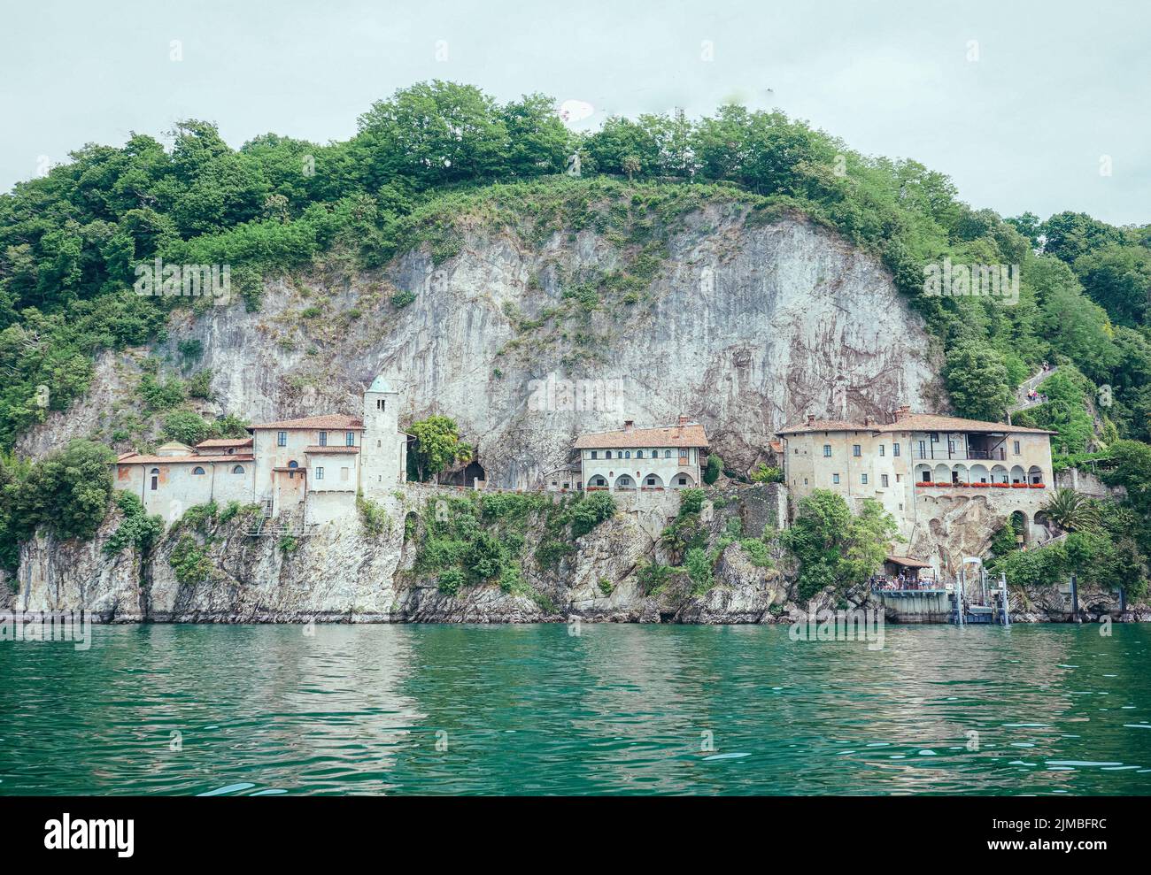 The Santa Caterina del Sasso monastery on rocky ridge in Italy Stock ...