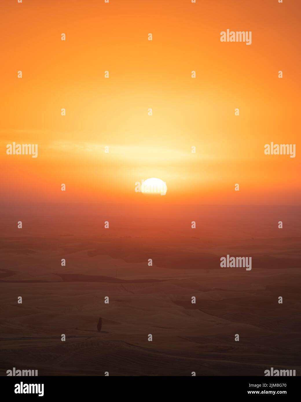 The breathtaking orange and yellow sunset sky over the field Stock ...