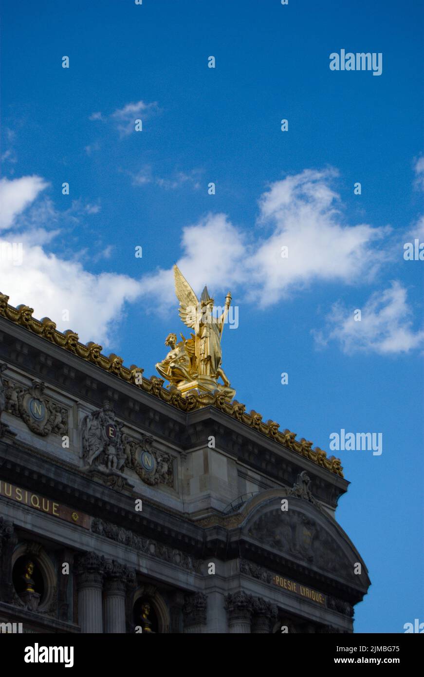 A vertical shot of a gilded angel statue on the top of the Garnier ...