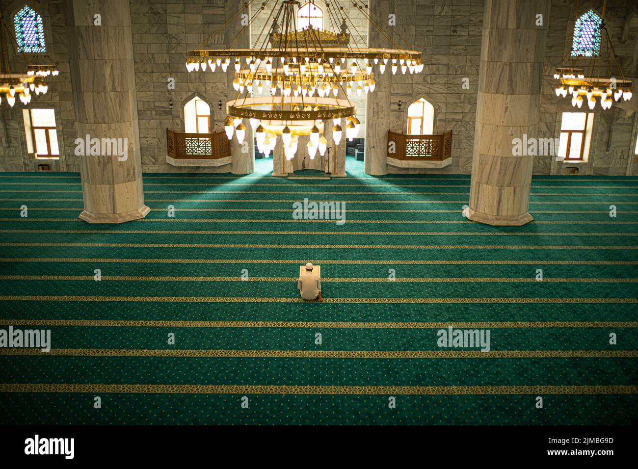 An aerial view of Muslim mosque interior with praying human Stock Photo ...