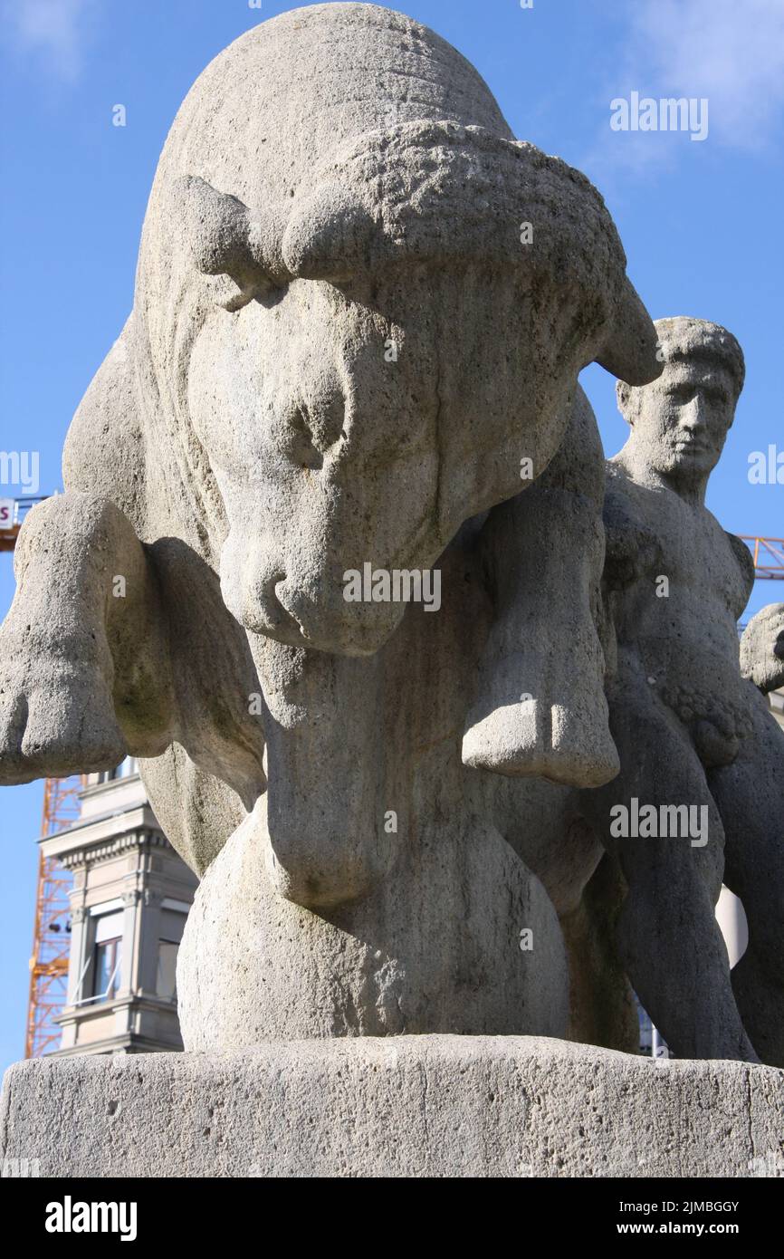 A vertical shot of the statue of a man with a bull in Zurich ...