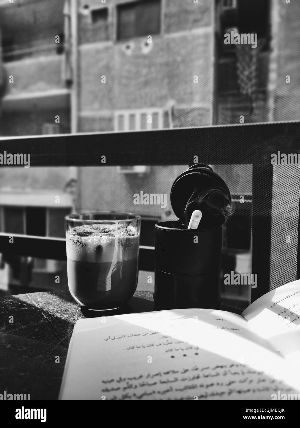 Cup of coffee with book on table Black and White Stock Photos & Images ...