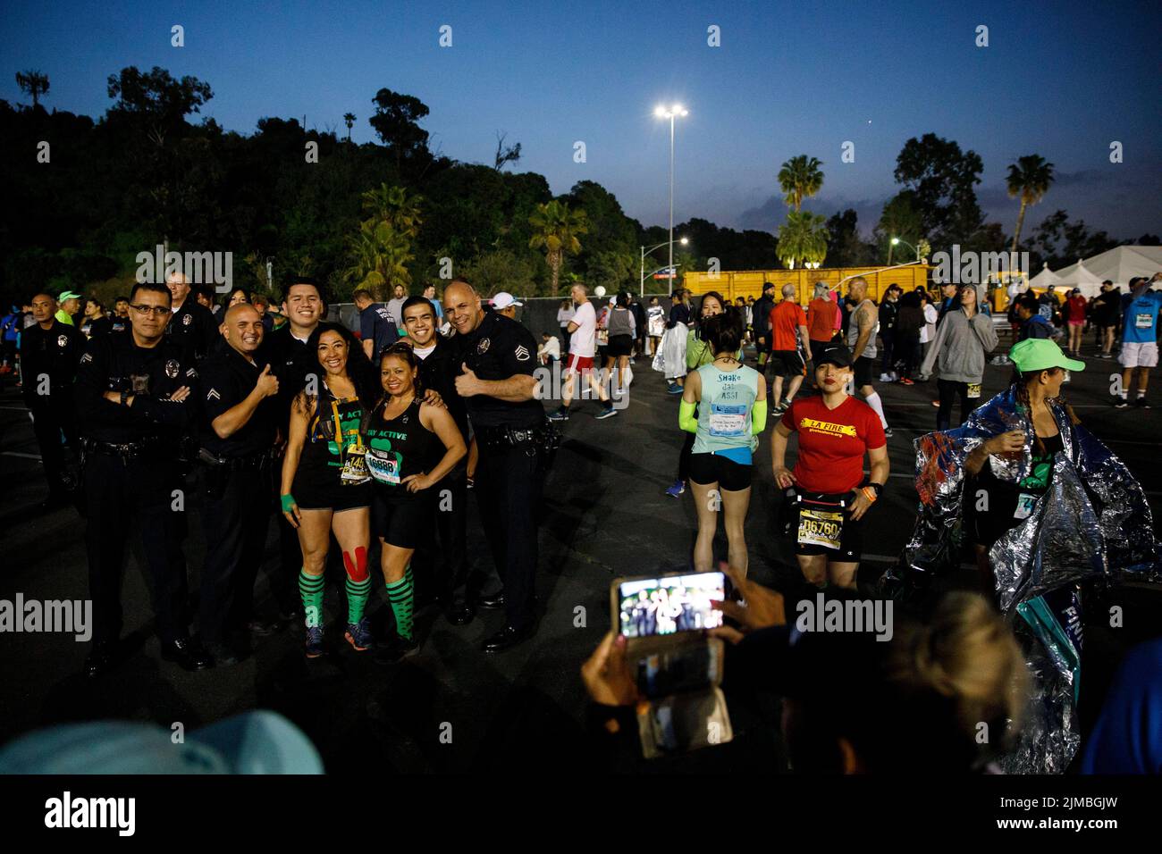 Los Angeles, CA, USA. 24th Mar, 2019. Runners take a photo with LAPD ...