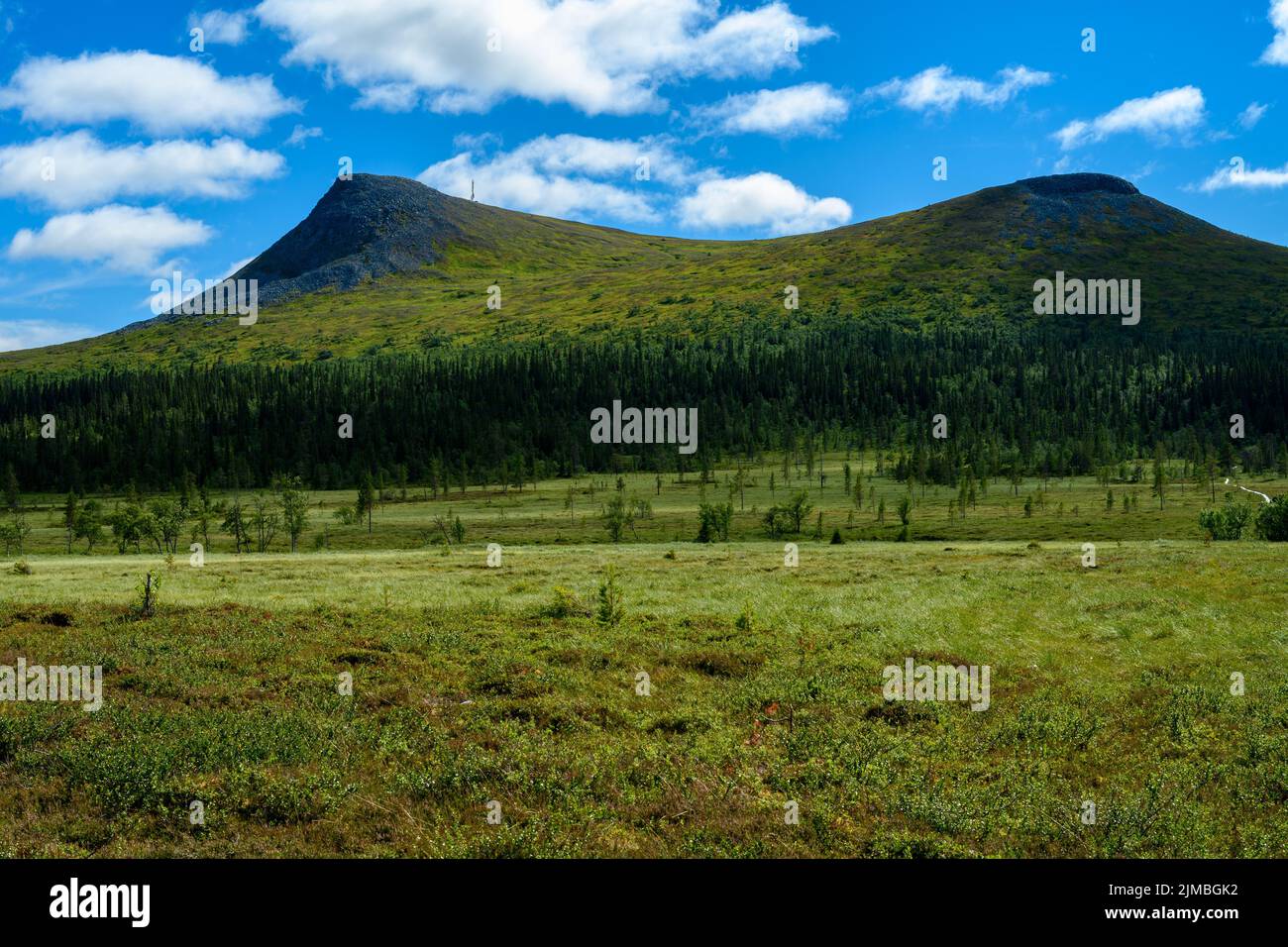 A shot of a beautiful countryside landscape with mountains and grassy ...