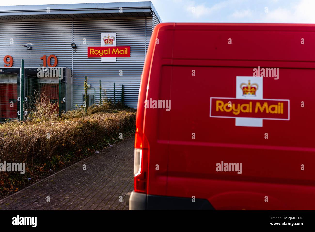 The Royal Mail Centre with red transit postal van parked outside ...
