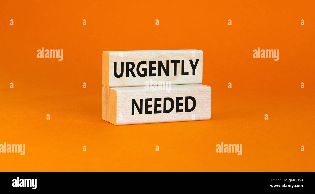 Urgently needed symbol. Concept words Urgently needed on wooden blocks ...