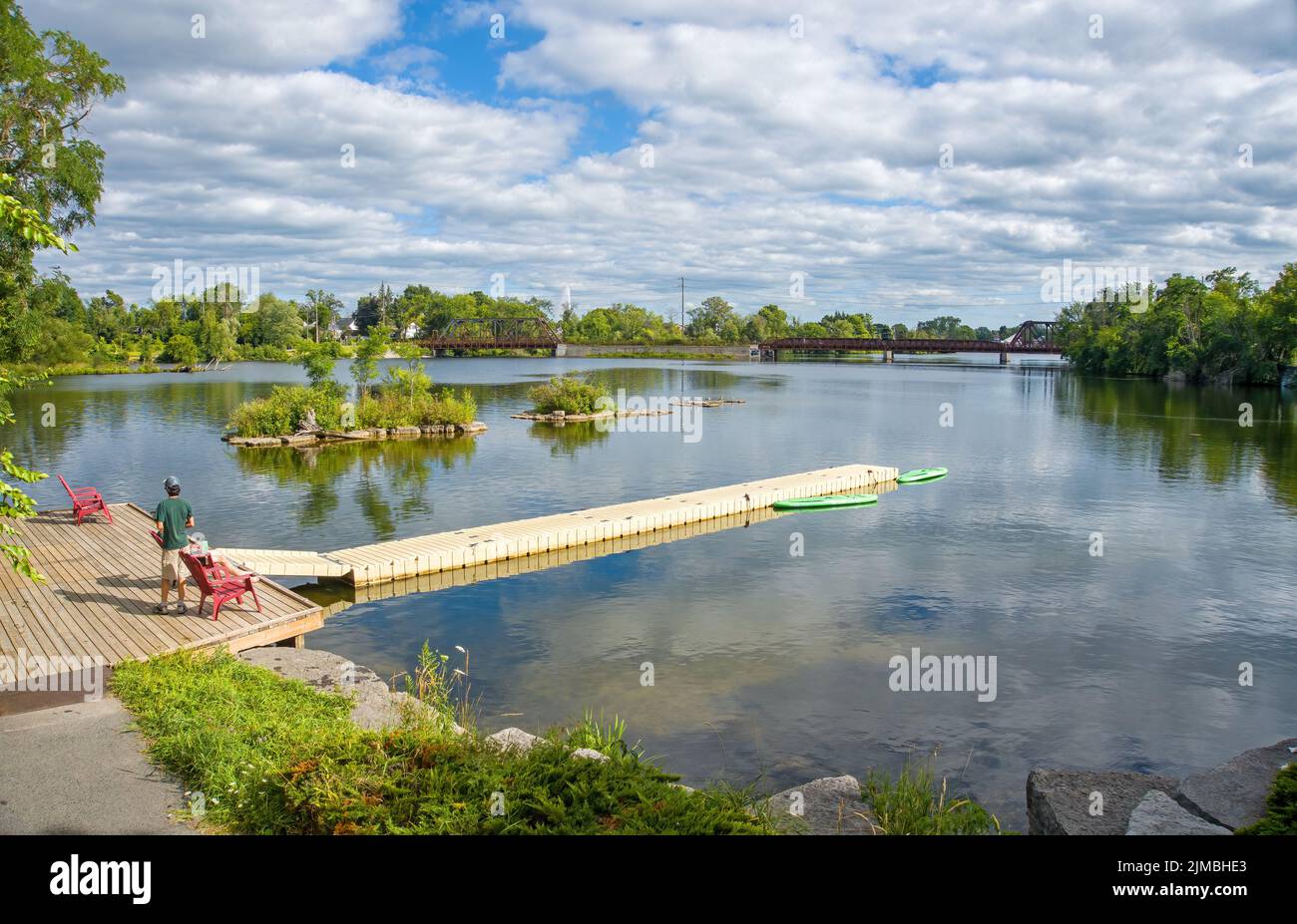 Scenic view of Little Lake with people relaxing on the pier deck from ...