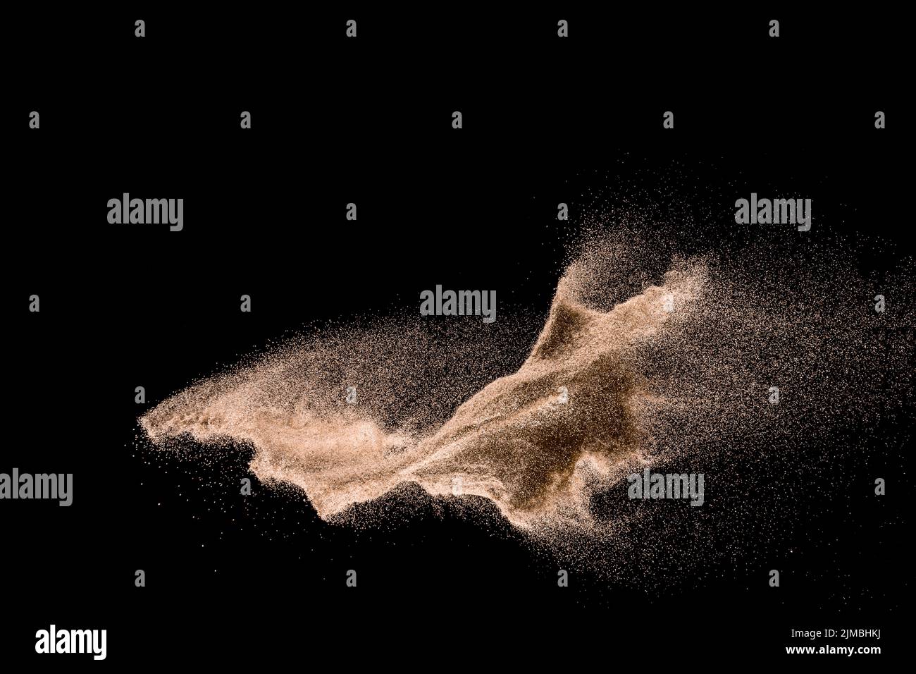 Dry river sand explosion. Golden colored sand splash against dark ...