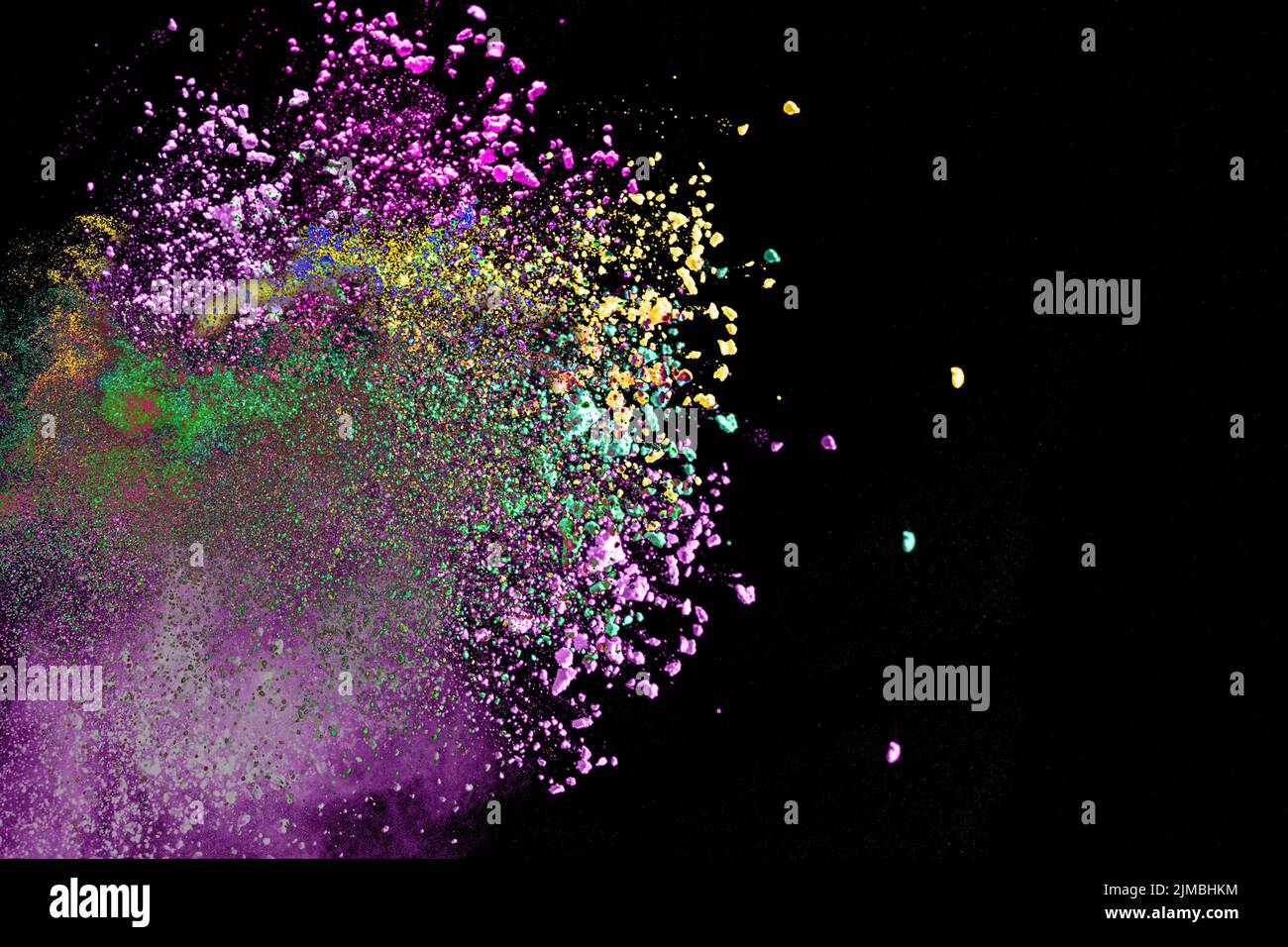 Multi color powder explosion on black background. Colored dust splash ...
