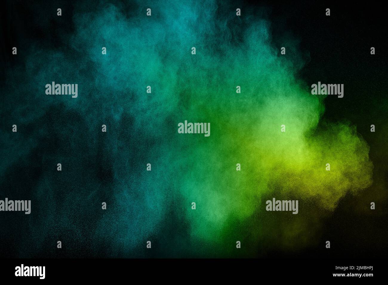 Green color powder explosion cloud on black background.Green dust ...